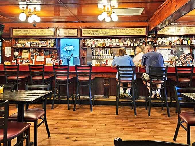 Dark wood, bottles lined up like old friends, and bar stools that practically pull you in by the collar.