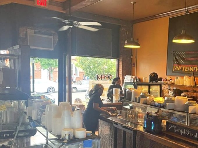 Inside, exposed brick and pendant lights create an atmosphere where comfort food meets genuine community warmth.