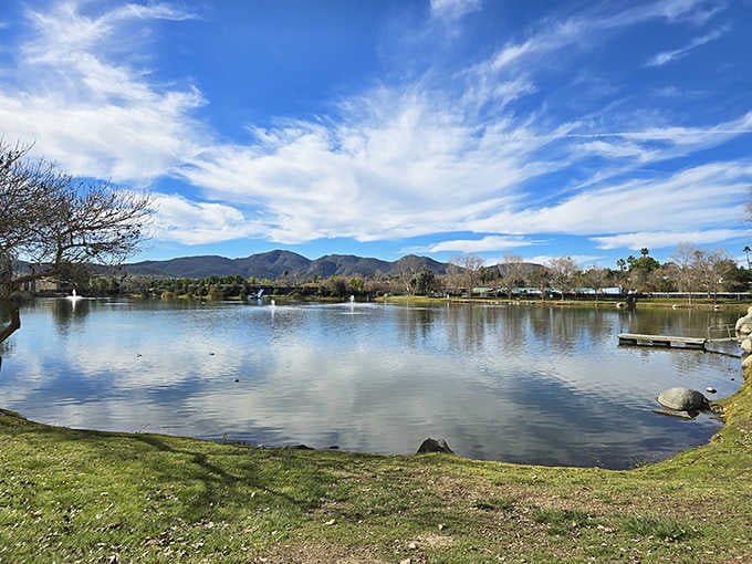 Mountains frame this serene lake like nature's own picture postcard, complete with clouds that look hand-painted by Bob Ross.