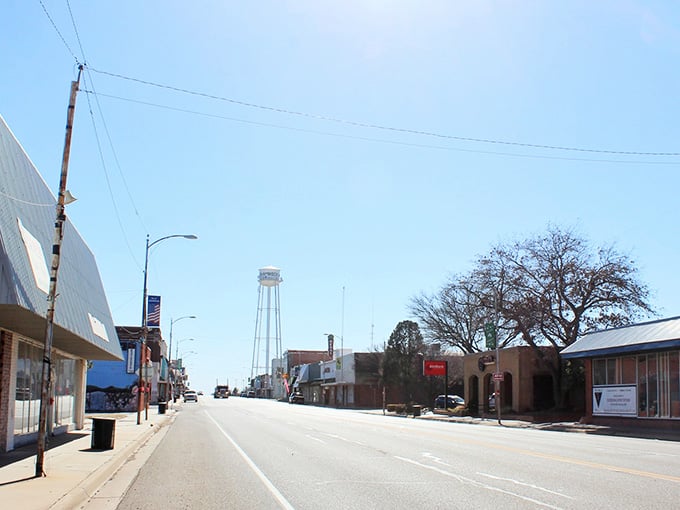 That water tower standing tall over empty streets tells you everything about small-town Texas pride and quiet determination.