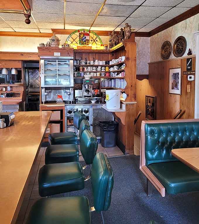 Those green vinyl booths and warm wood paneling create the exact atmosphere every breakfast should have.