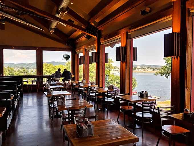 Sunlight pours through massive windows, turning every meal into a front-row seat to river magic.