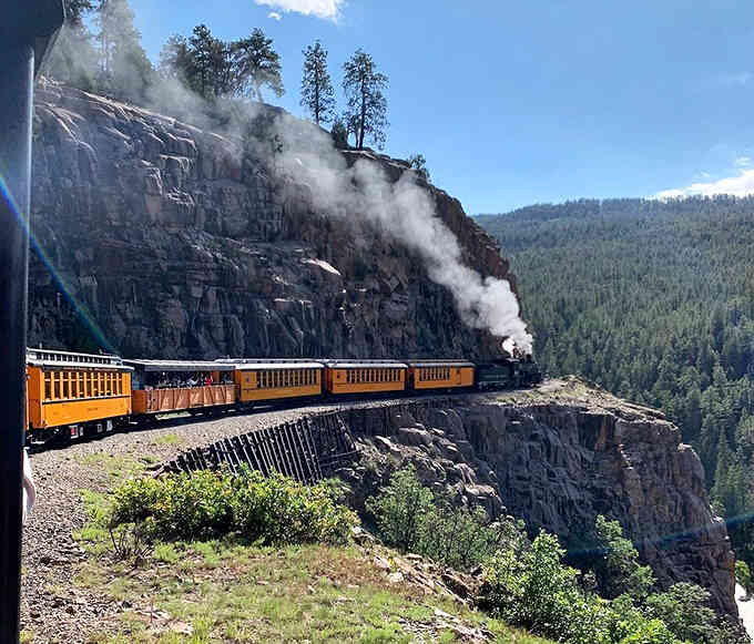 The Durango & Silverton train chugging through the mountains, because getting there is half the adventure.