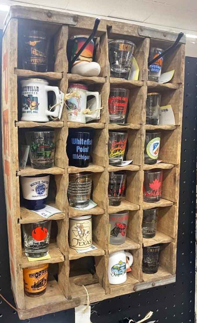 A wooden crate full of souvenir shot glasses, because every road trip deserves a tiny, affordable memento to remember it by.