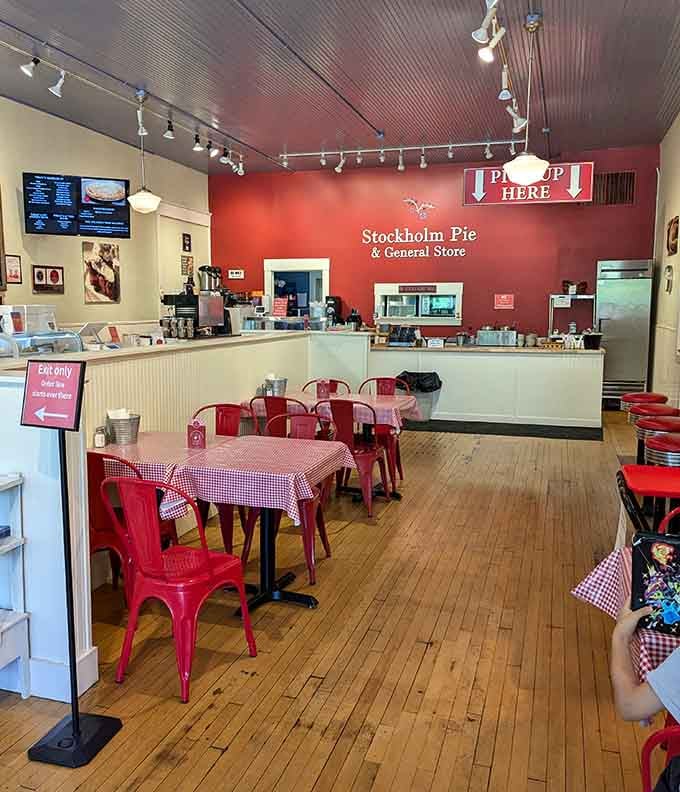 Red wall, wooden floors, and gingham tablecloths create the coziest pie headquarters you've ever seen.