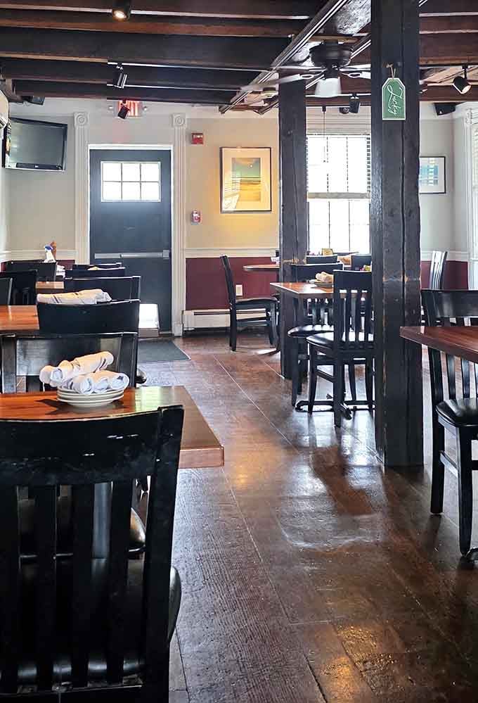 Dark beams, worn hardwood floors, and rolled napkins waiting patiently, this room has seen a century of good conversations.