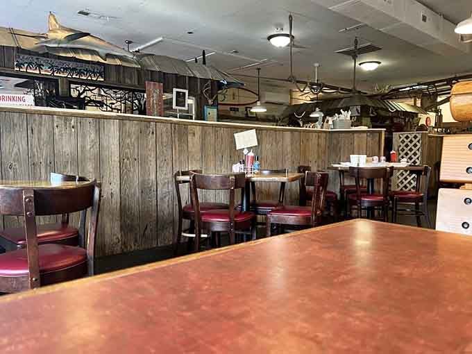 Rustic wood panels, red cushioned seats, and ceiling treasures that could fill a museum, or at least a great story.