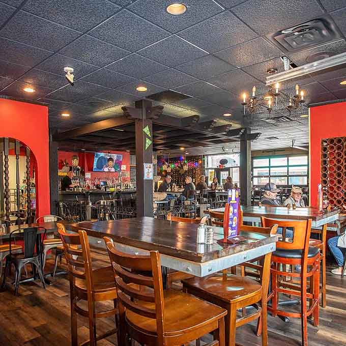 Bold red walls, warm wood tables, and a full bar that means business. Welcome to El Rey.