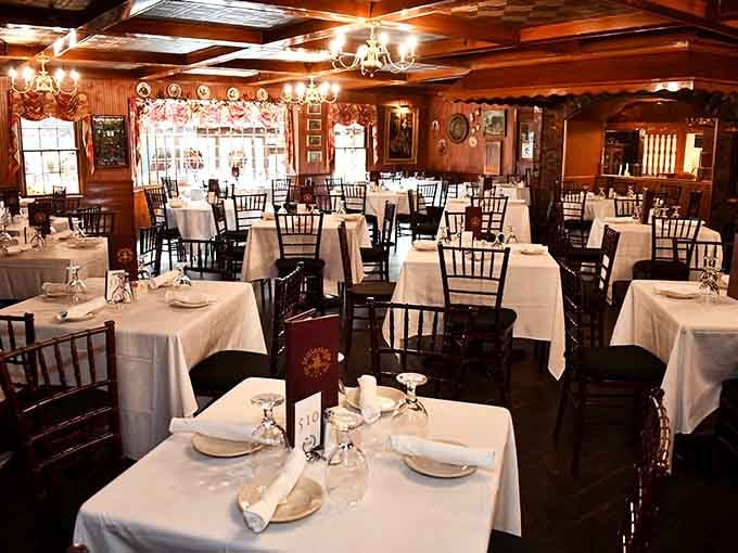 White linens, warm wood, and chandeliers glowing softly. Your grandmother would approve of this dining room.