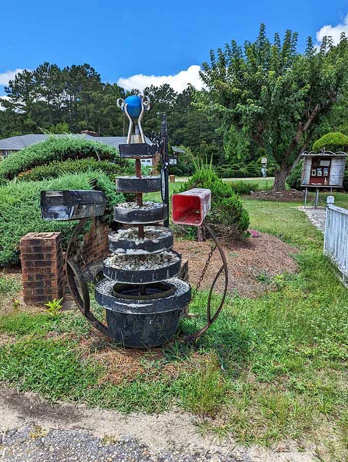 Stacked tires, mismatched mailboxes, and a bold blue globe on top, proof that one person's junk is another's masterpiece.