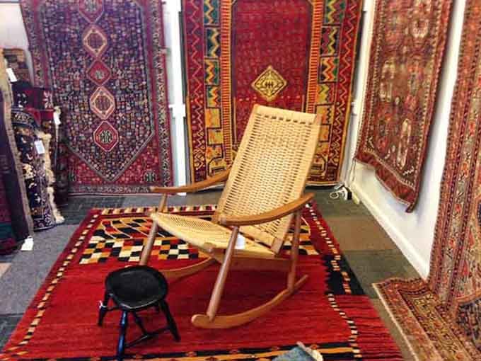 That woven rocking chair surrounded by rich Persian rugs is basically begging you to sit down and stay awhile.