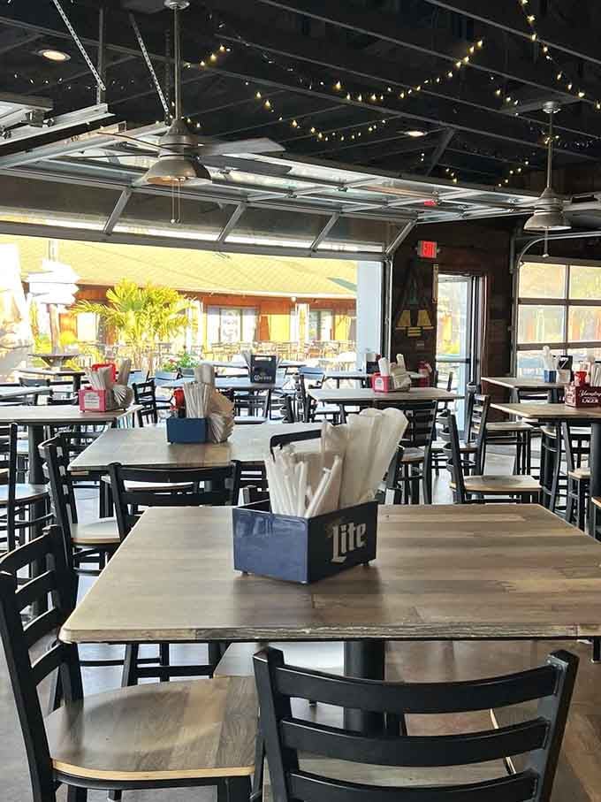 String lights, ceiling fans, and garage doors wide open, this indoor space feels like a permanent vacation.