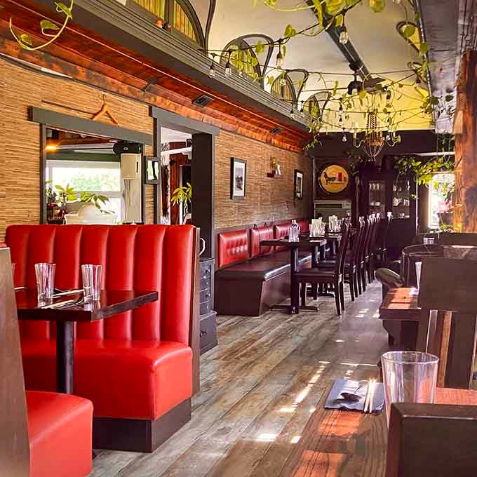 Red leather booths, trailing vines, and string lights overhead. This is what a good idea looks like from the inside.