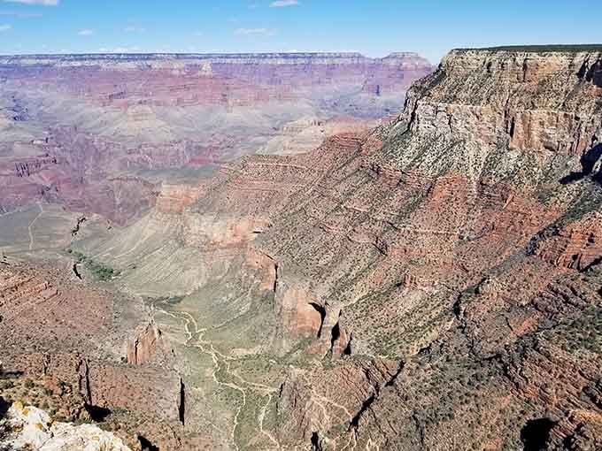 From up here, the Bright Angel Trail looks like a tiny thread stitching the canyon together, stitch by magnificent stitch.
