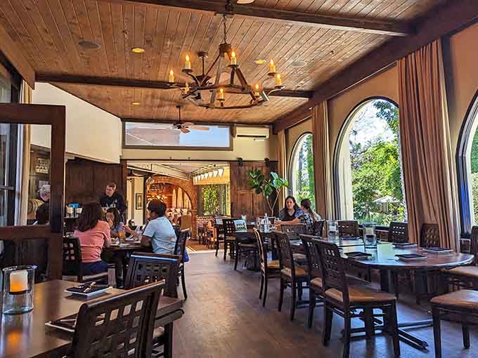 Warm wood ceilings, arched windows, and soft light make this dining room feel like a hug you didn't know you needed.