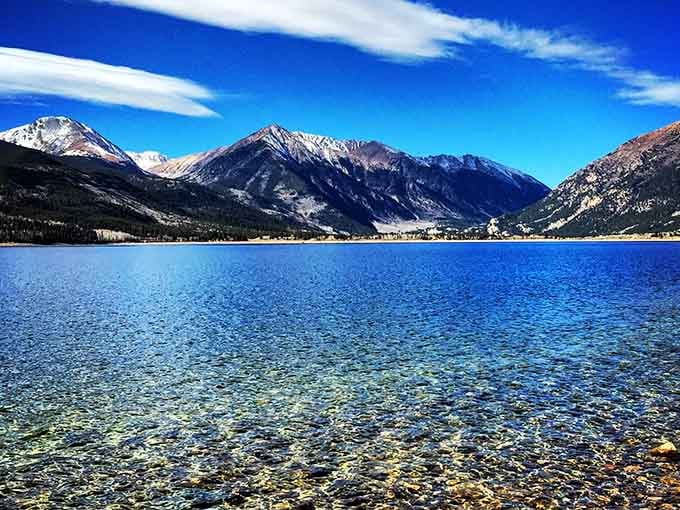 Crystal-clear water revealing every pebble below, with rugged peaks standing guard above, this lake means serious business.