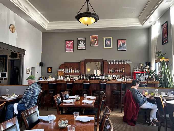 High ceilings, vintage posters, and that gorgeous bar create an atmosphere that whispers "romance" without being stuffy about it.