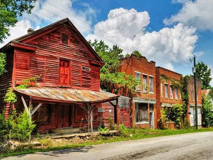 Red paint peeling like sunburned skin, these structures refuse to surrender completely to the relentless march of time.