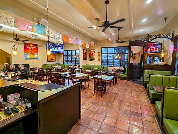 Terracotta floors, green booths, and papel picado banners overhead: this room says "stay a while" and means it.