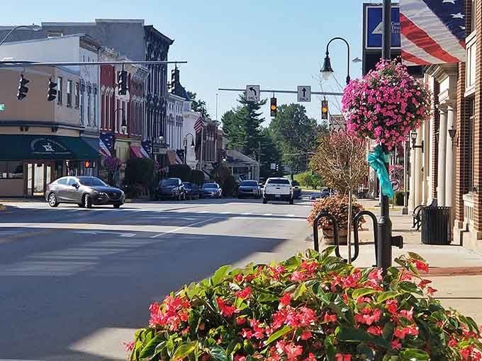 Downtown Versailles dressed up in flowers and flags, looking like Main Street USA decided to actually try for once.