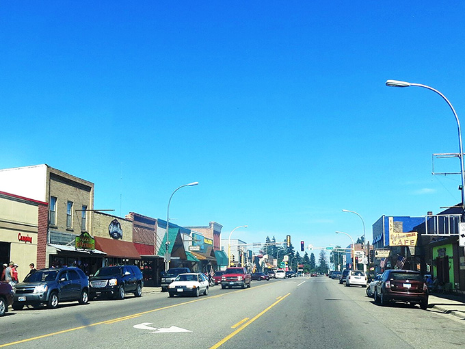 Blue skies over Main Street reveal why people trade their GPS for serendipity in this lakeside gem.