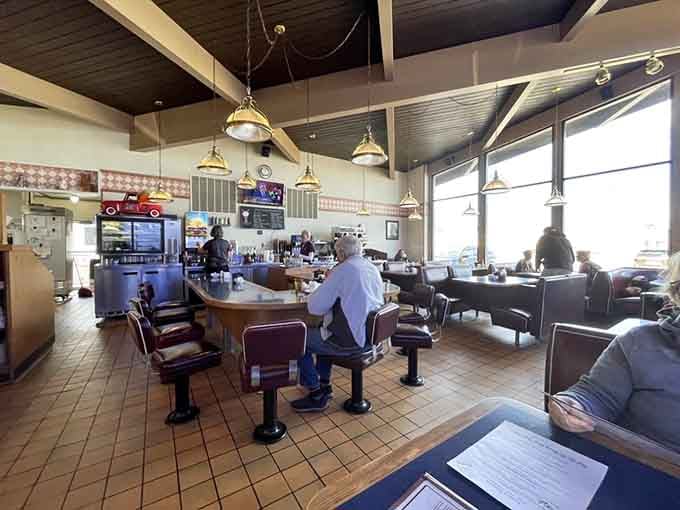 A counter, some stools, brass lights overhead, and coffee waiting. This is exactly where you need to be right now.