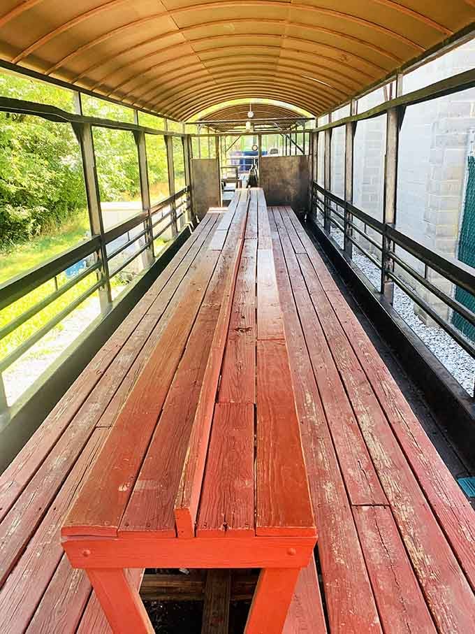 Those warm reddish-brown wooden benches stretch out like an open invitation to sit down and let the world slow down.