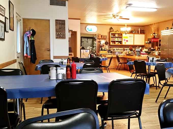 Blue tablecloths, black chairs, and a ceiling fan turning slowly. This is what "come as you are" actually looks like.