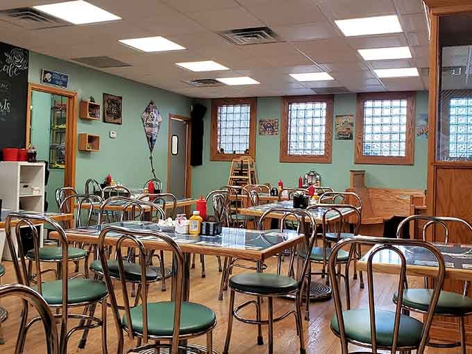 Sage green walls, chrome chairs, and glass block windows, this dining room means serious, comfortable business.