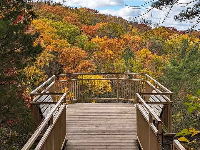 That wooden observation deck isn't just a viewpoint, it's a front-row seat to Wisconsin's most spectacular fall color performance.