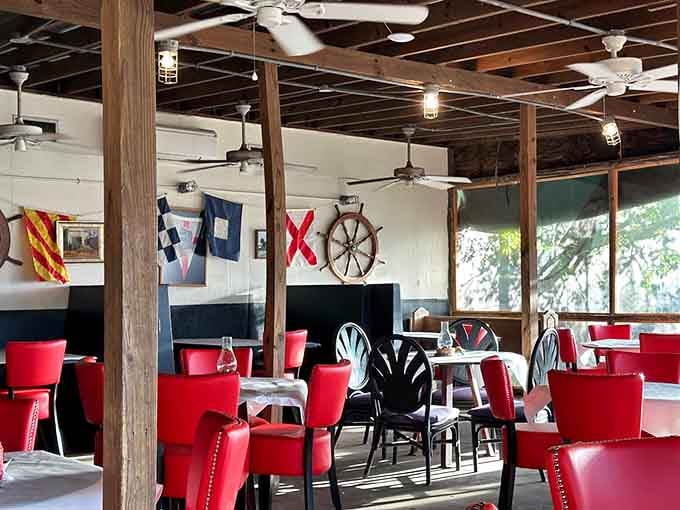 Nautical flags, a ship's wheel, and red chairs that pop, this dining room has more personality than most five-star restaurants.