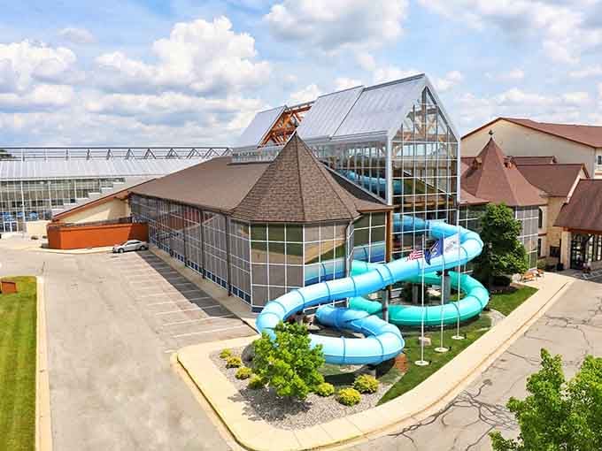 Those turquoise slides spiraling out of the building are basically the park's way of waving hello from the parking lot.