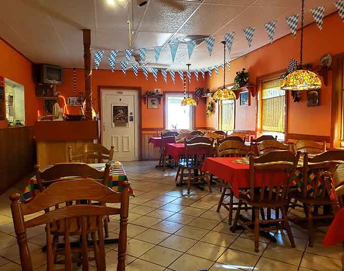 Warm orange walls, Bavarian pennants, and Tiffany lamps overhead, this dining room feels like a hug you didn't know you needed.