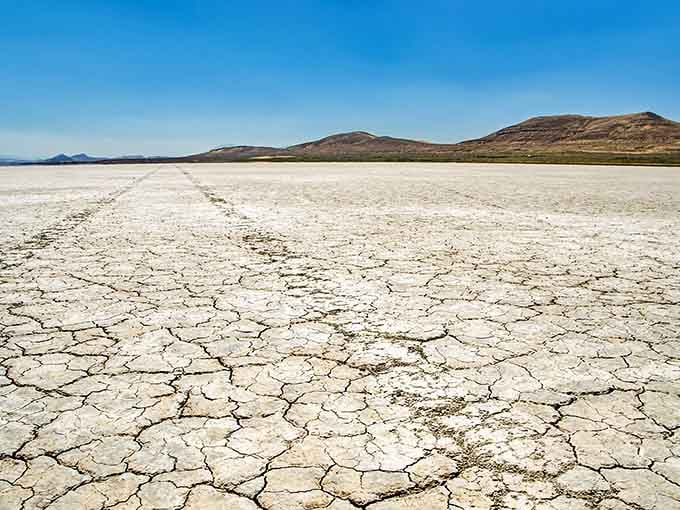 The cracked earth stretches to distant mountains, creating a landscape that feels wonderfully empty and peaceful.