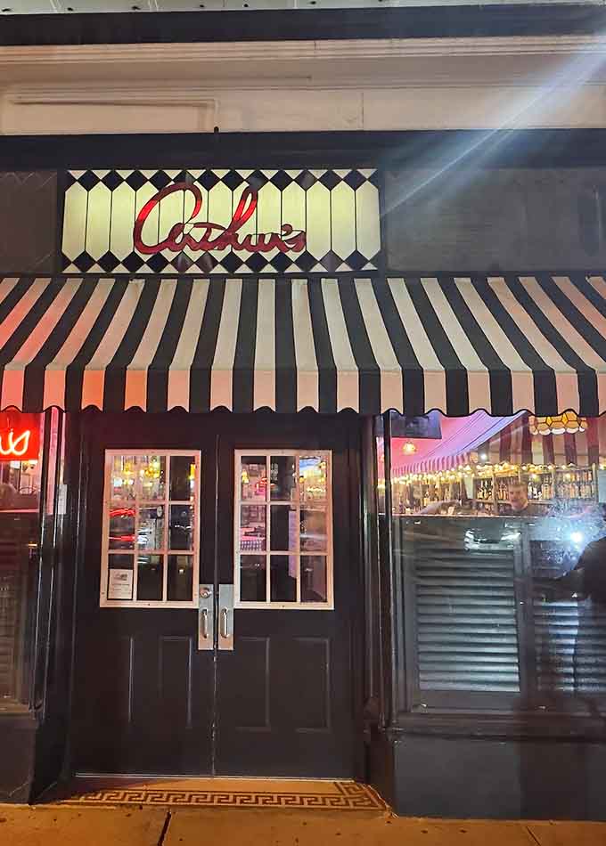 That glowing red cursive sign and bold striped awning make Arthur's Tavern impossible to walk past without stopping.
