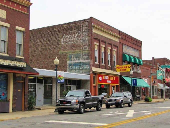 Faded Coca-Cola signs whisper stories of decades past while modern life hums along these timeless downtown streets.