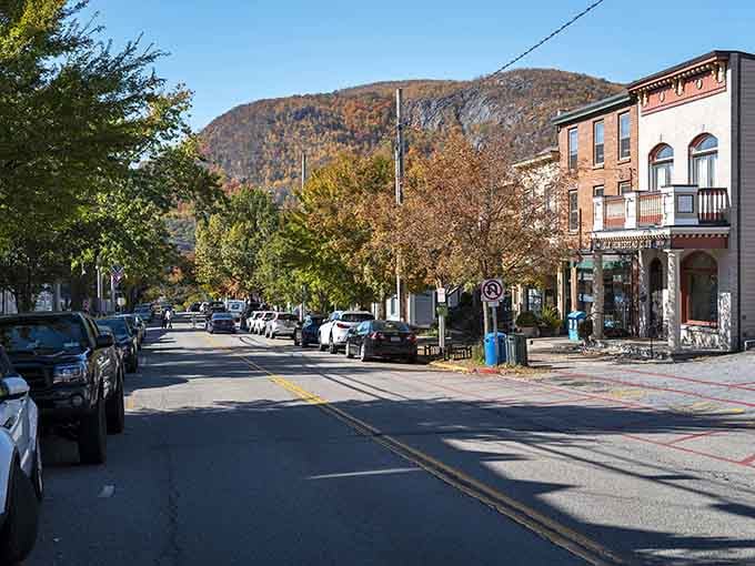 Autumn paints Cold Spring's main street in golden hues while mountains stand guard like nature's own security detail.