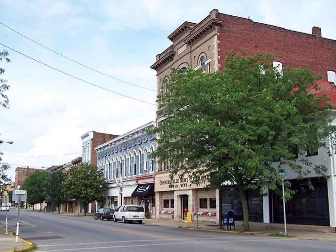 Connersville's tree-lined downtown feels like a deep breath, brick buildings standing tall beneath a summer sky.