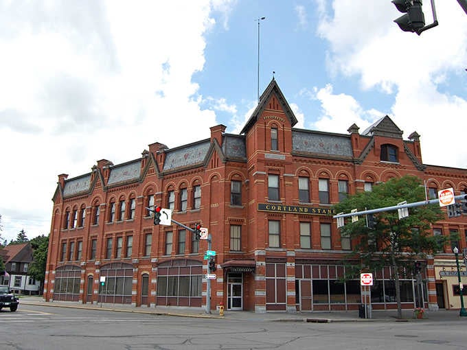 The Cortland Standard building's ornate roofline and rich red brick make every other corner look like it's not even trying.