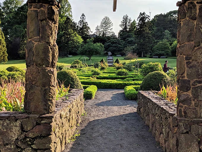 Framed by ancient stone columns, this formal garden feels like stumbling into a secret that Versailles forgot to mention.