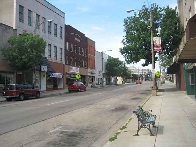 That perfect sidewalk bench waits for someone to sit down and watch the world go slowly by.