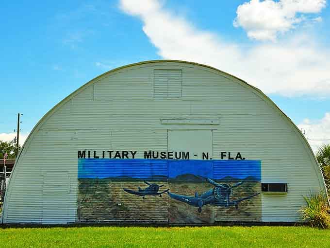 That hand-painted mural on a genuine Quonset hut is the most honest museum sign you'll ever see.