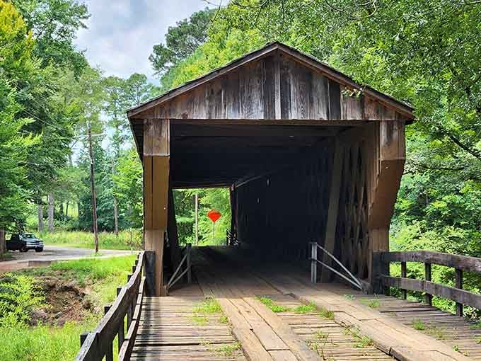 Peering through this weathered tunnel feels like looking through a portal to simpler times when bridges had personality and character.