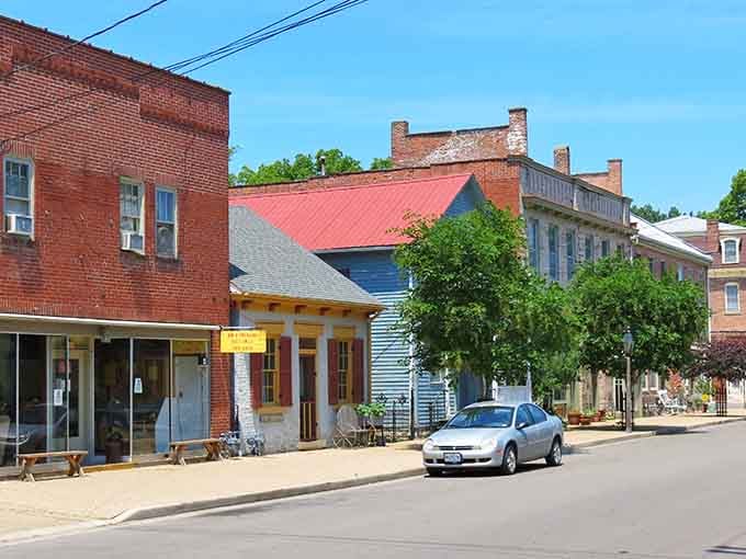 Sainte Genevieve's sun-drenched street mixes cheerful yellow shutters with centuries-old brick, proof that good design never really goes out of style.