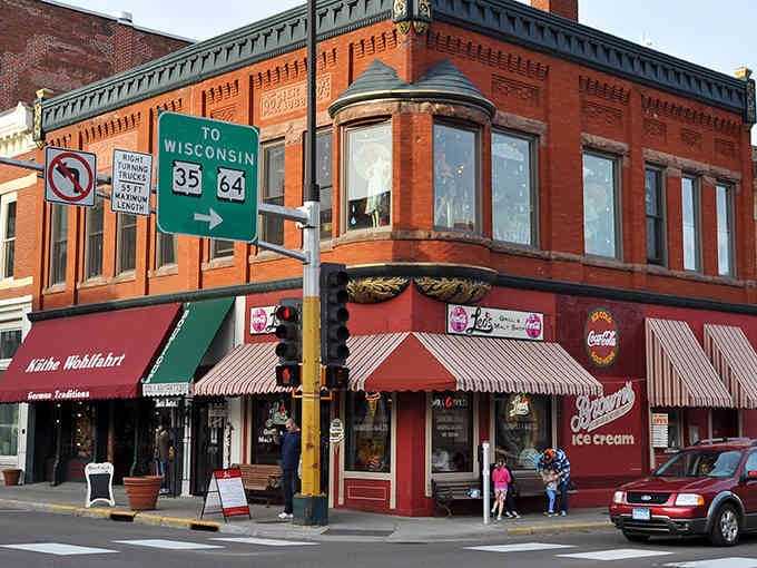 Those red-striped awnings and ornate brickwork remind you that some towns never forgot how to look charming.