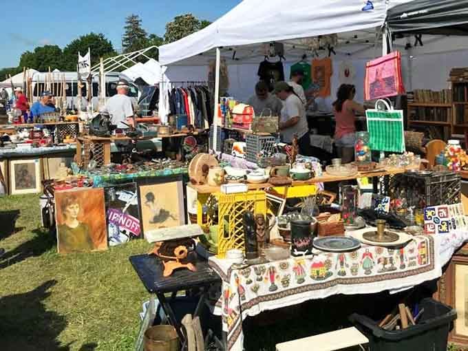 Vintage portraits, decorative plates, and colorful collectibles crowd every table under the bright Stormville summer sky.