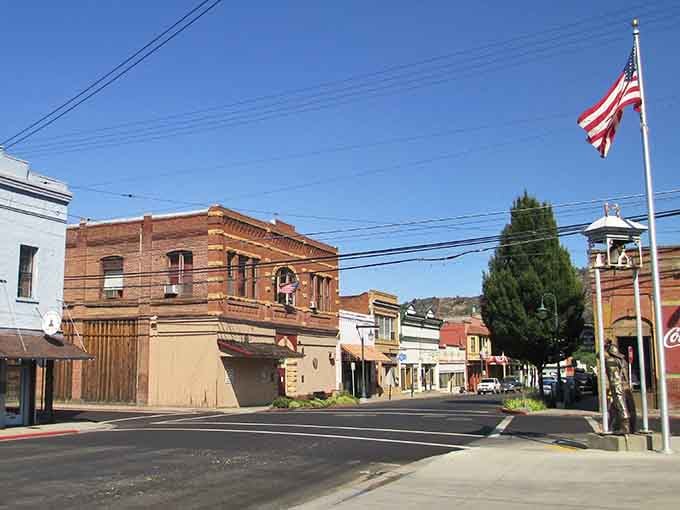 A proud brick corner building and a tall American flag say Yreka means serious, dignified business.
