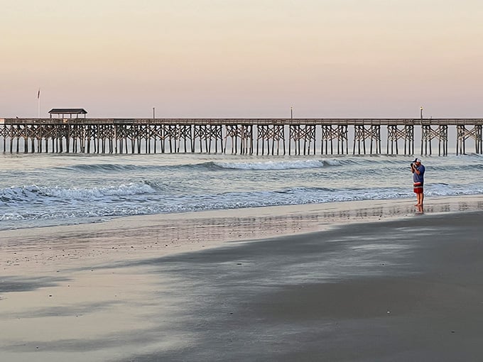 That historic pier stands sentinel at sunset, watching over waves that have rolled in since your grandparents' day.