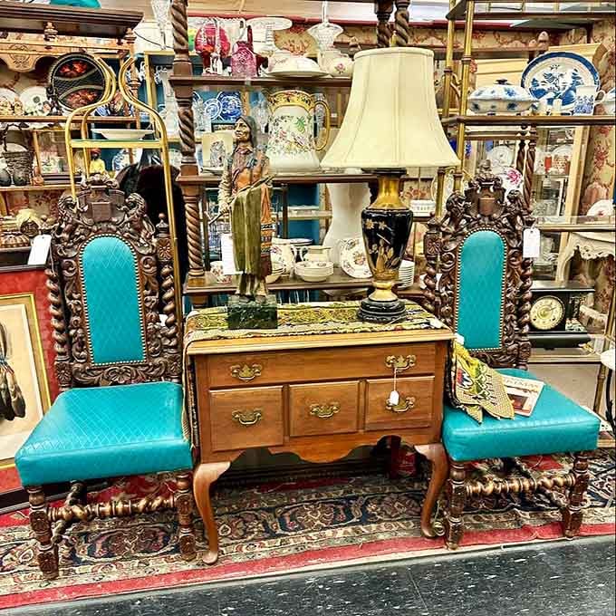 Those turquoise chairs flanking the vanity create a color pop that would make any mid-century designer smile with approval.