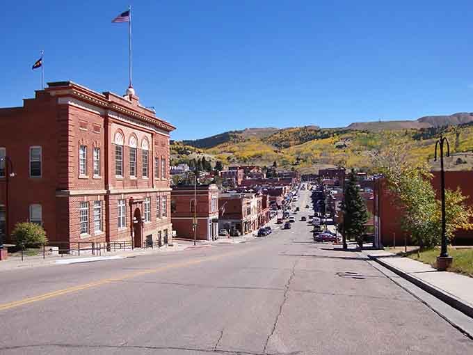 That grand red courthouse stands proud under autumn skies, a testament to Cripple Creek's glory days and enduring spirit.